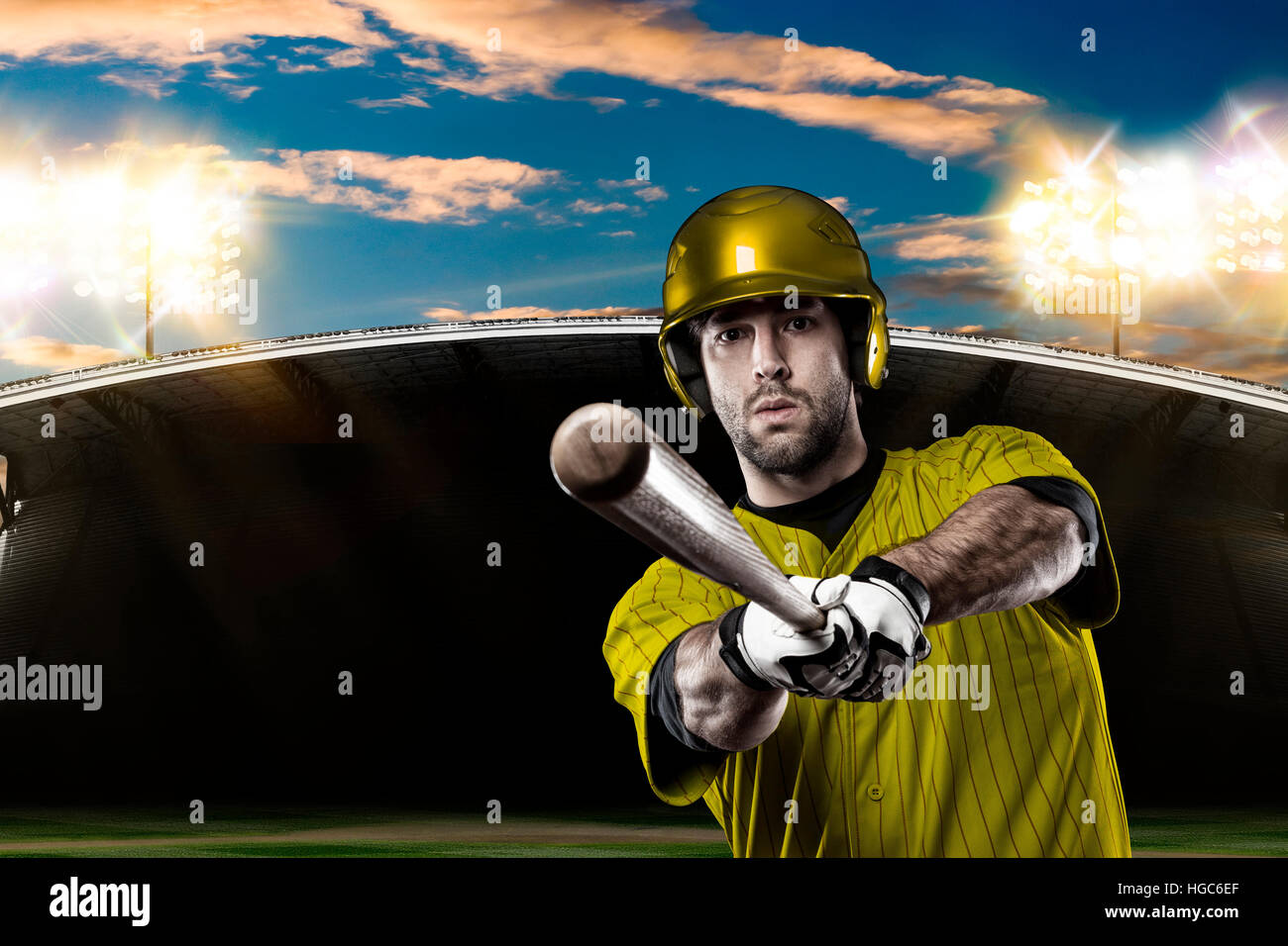 Baseball Player with a yellow uniform on baseball Stadium Stock Photo ...