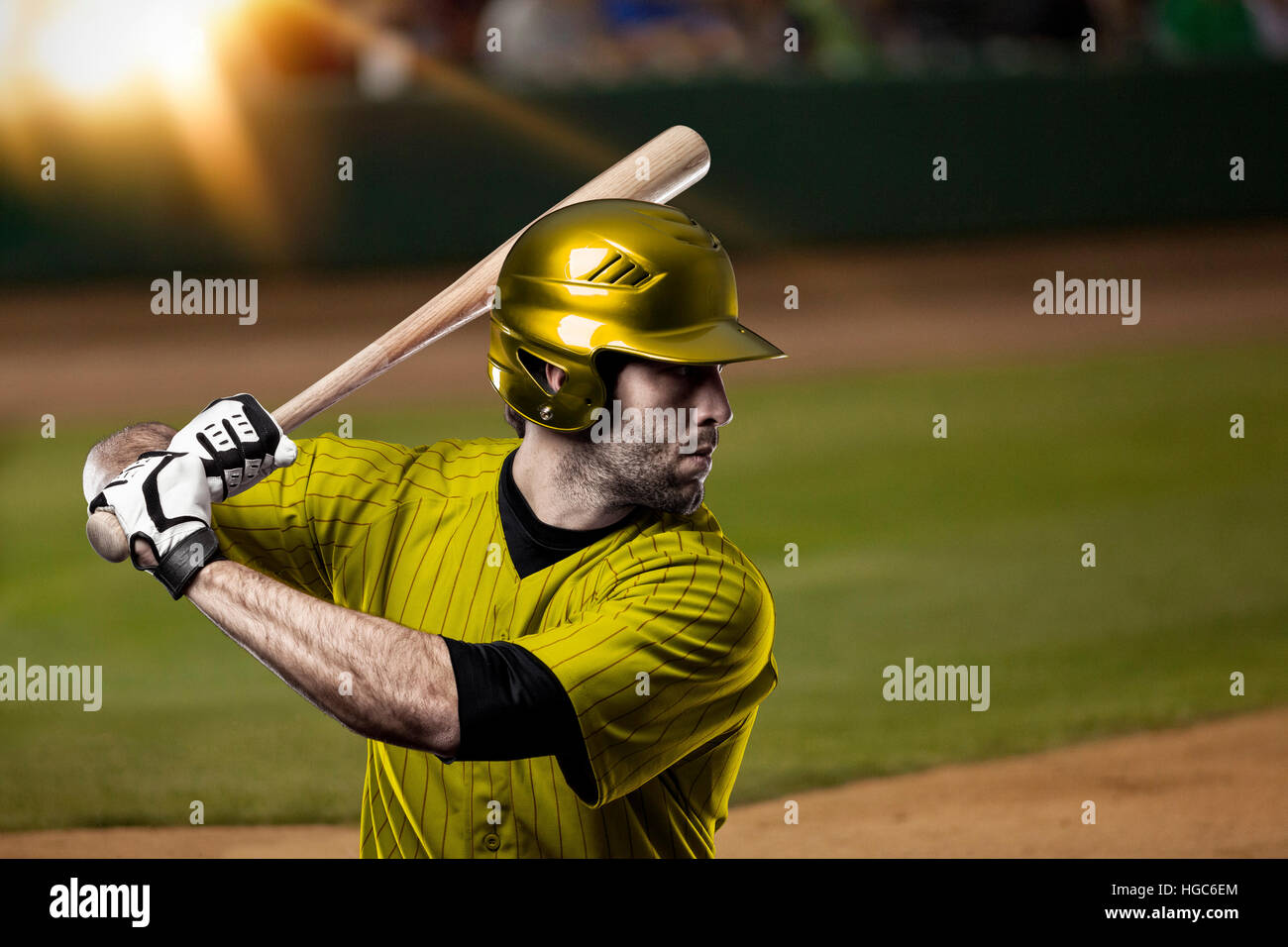 Baseball Player with a yellow uniform on baseball Stadium Stock Photo ...