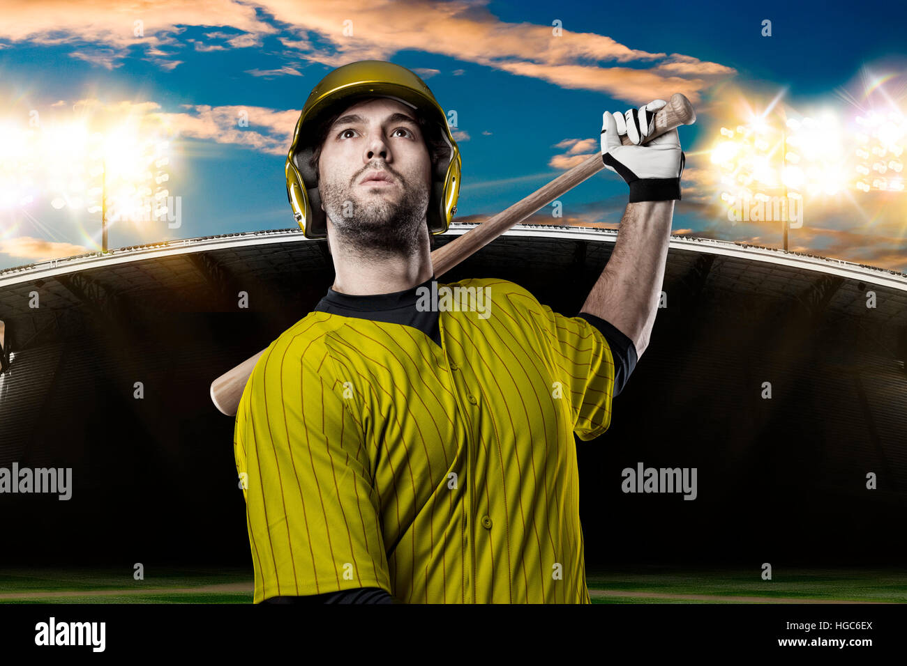 Baseball Player with a yellow uniform on baseball Stadium Stock Photo ...