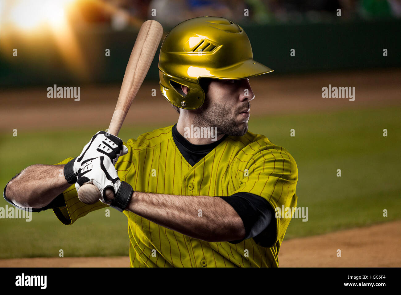 Baseball Player with a yellow uniform on baseball Stadium Stock Photo ...
