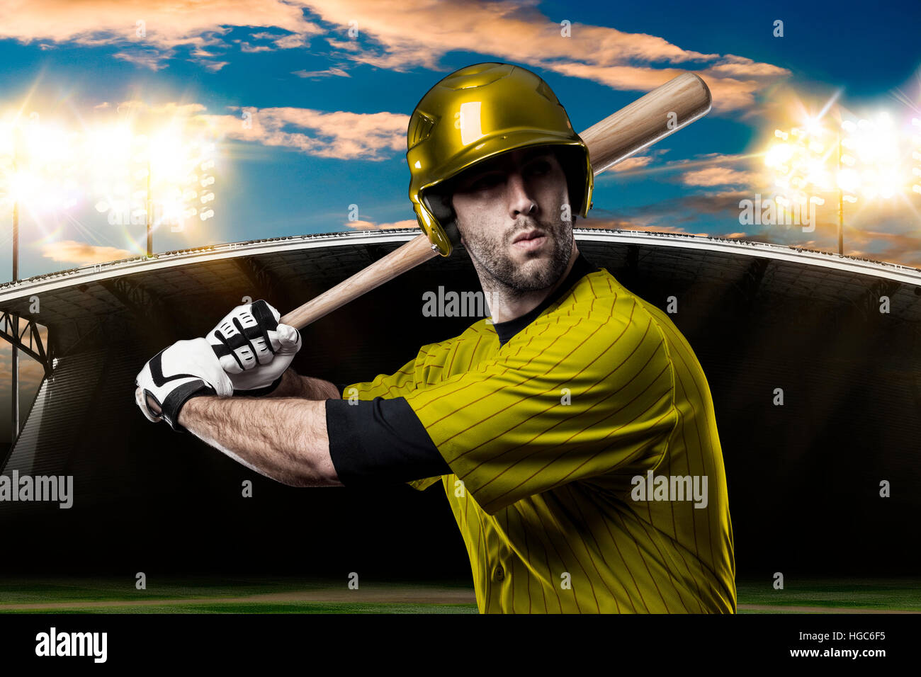 Baseball Player with a yellow uniform on baseball Stadium Stock Photo ...