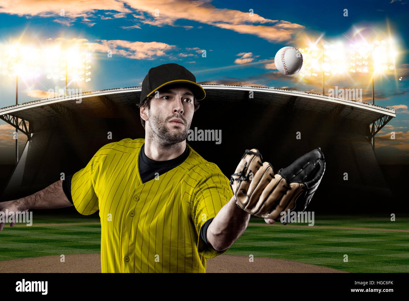 Baseball Player with a yellow uniform on baseball Stadium Stock Photo ...