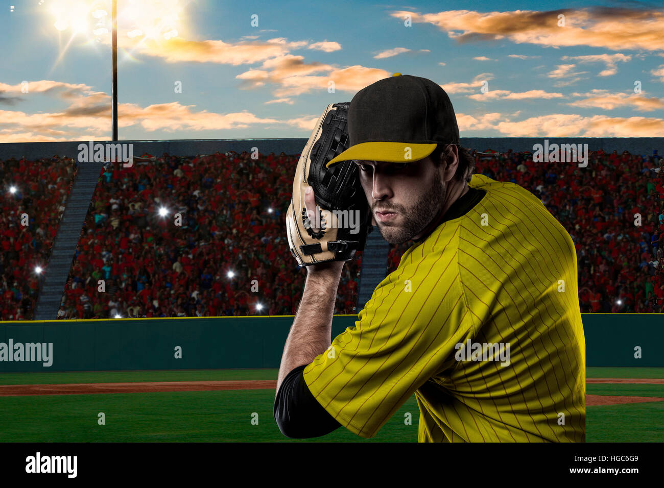 Pitcher Baseball Player with a yellow uniform on baseball Stadium Stock ...