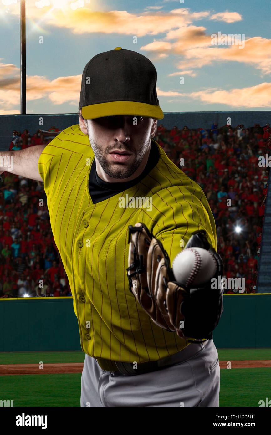 Baseball Player with a yellow uniform on baseball Stadium Stock Photo ...