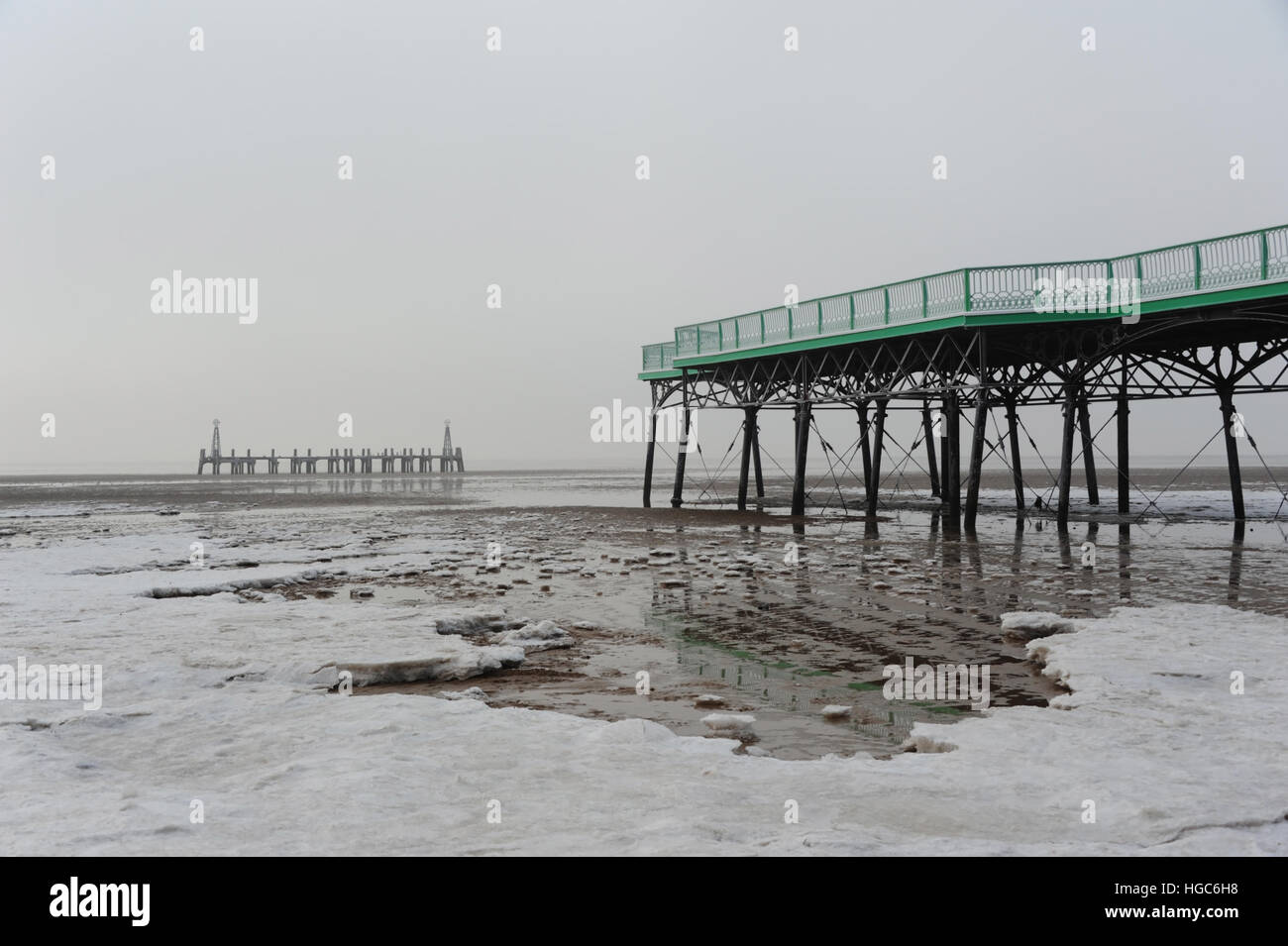 White expanse of land-fast sea ice on wet beach sand, south side of St ...