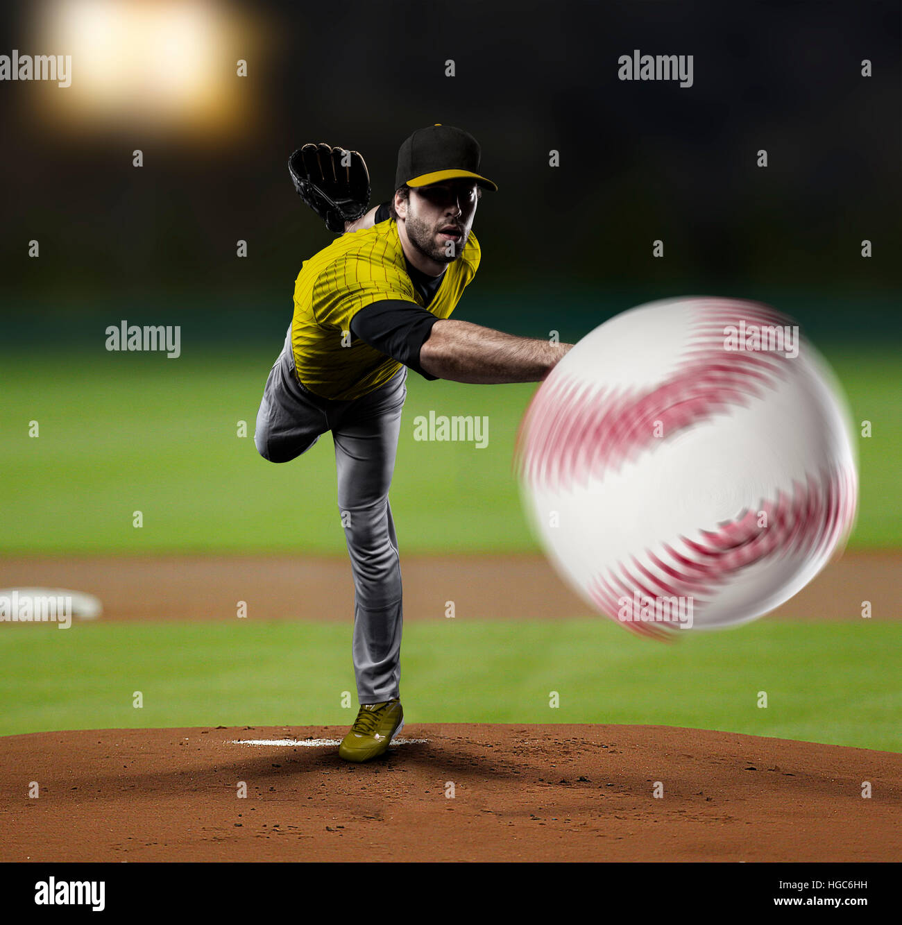 Pitcher Baseball Player with a yellow uniform on baseball Stadium Stock ...