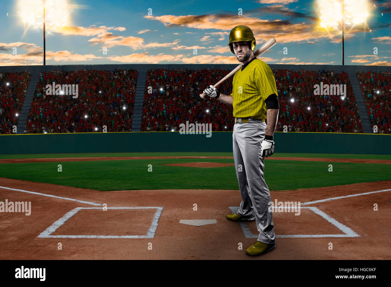 Baseball Player with a yellow uniform on baseball Stadium Stock Photo ...