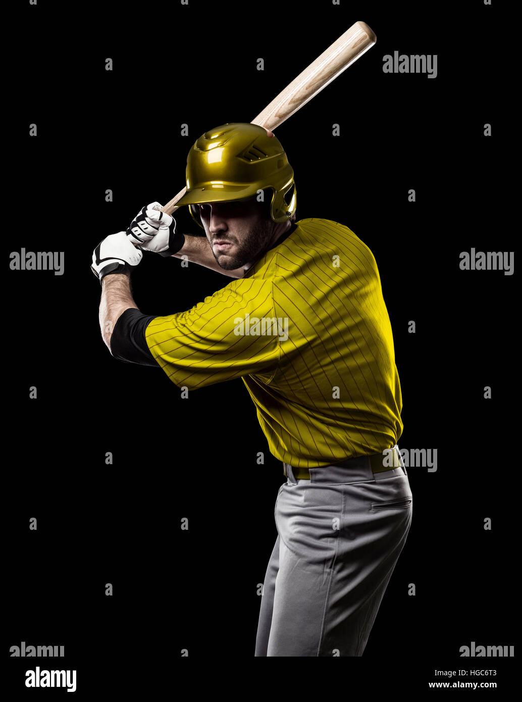 Baseball Player with a yellow uniform on a black background Stock Photo ...
