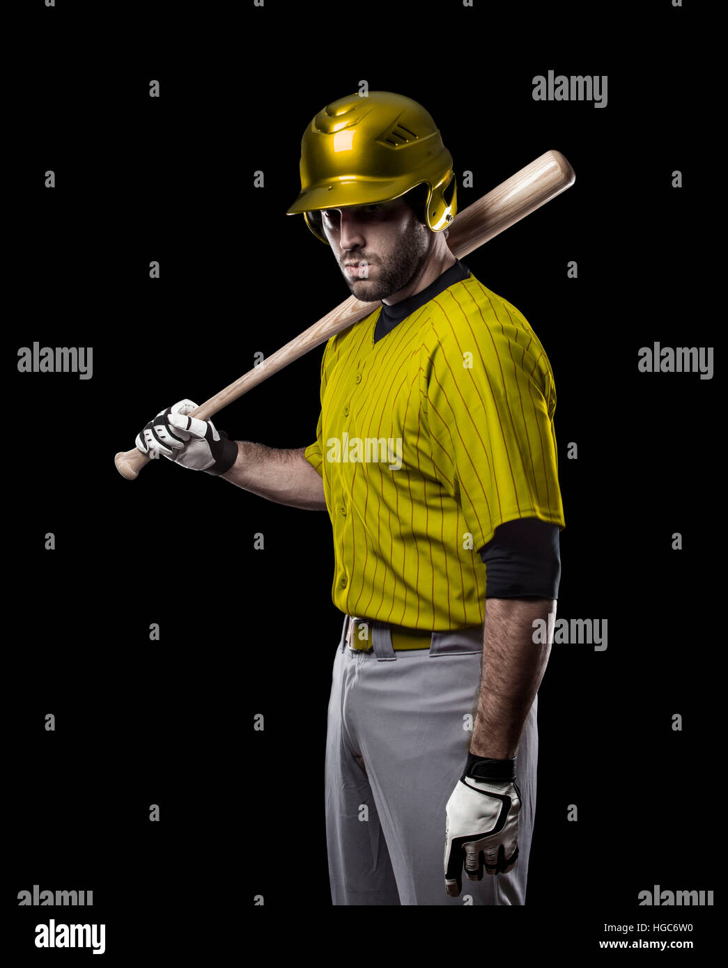 Baseball Player with a yellow uniform on a black background Stock Photo ...