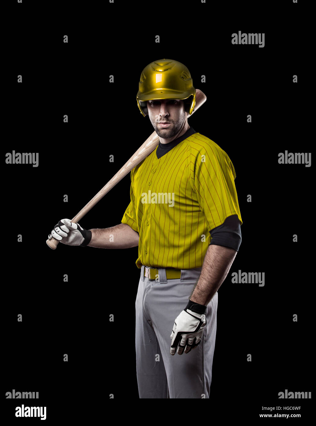 Baseball Player with a yellow uniform on a black background Stock Photo ...