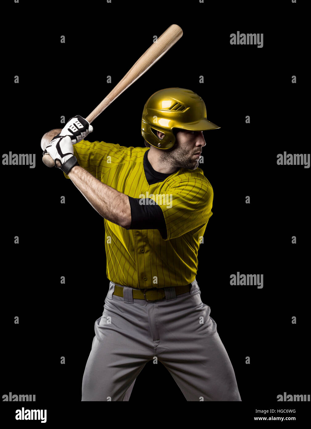 Baseball Player with a yellow uniform on a black background Stock Photo ...