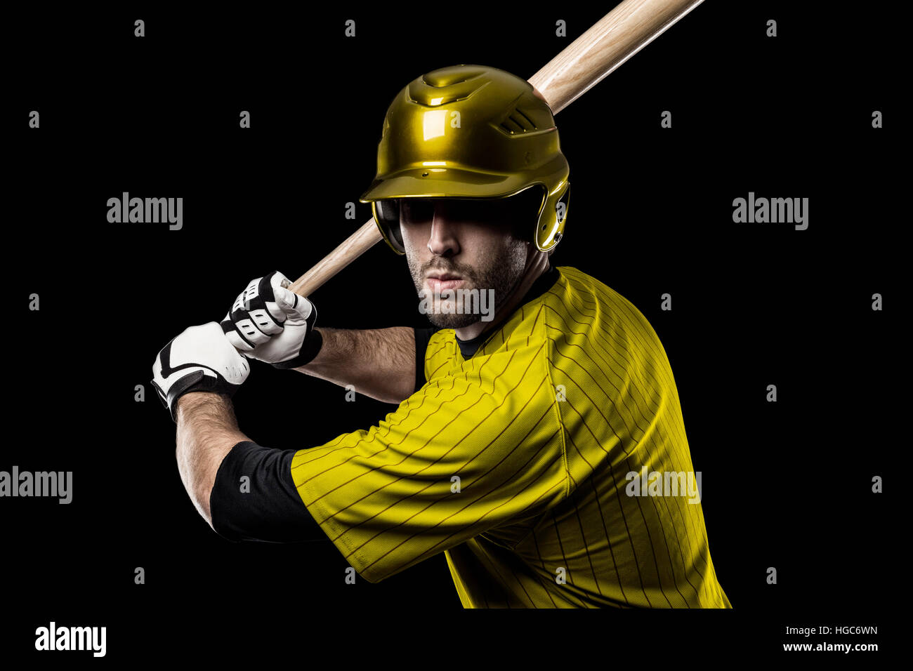 Baseball Player with a yellow uniform on a black background Stock Photo ...