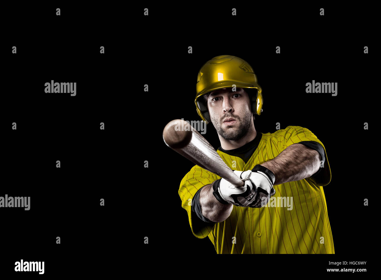 Baseball Player with a yellow uniform on a black background Stock Photo ...