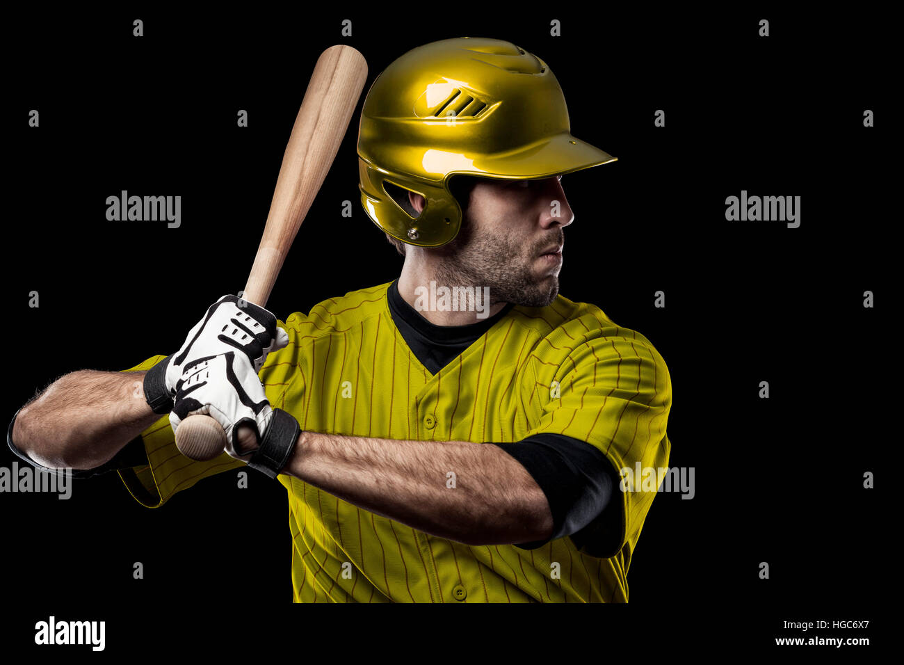Baseball Player with a yellow uniform on a black background Stock Photo ...