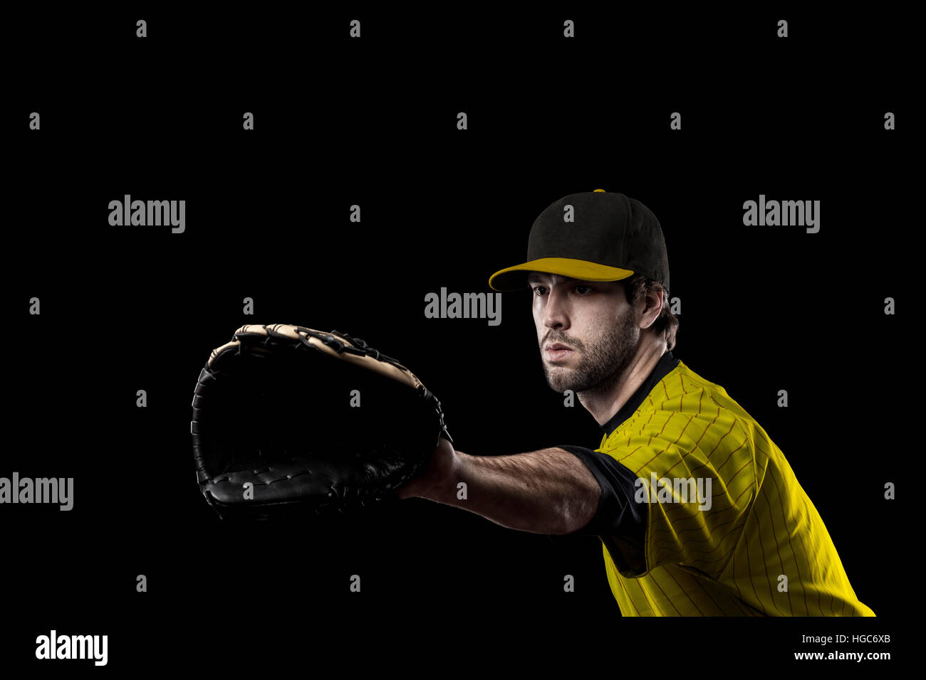 Baseball Player with a yellow uniform on a black background Stock Photo ...