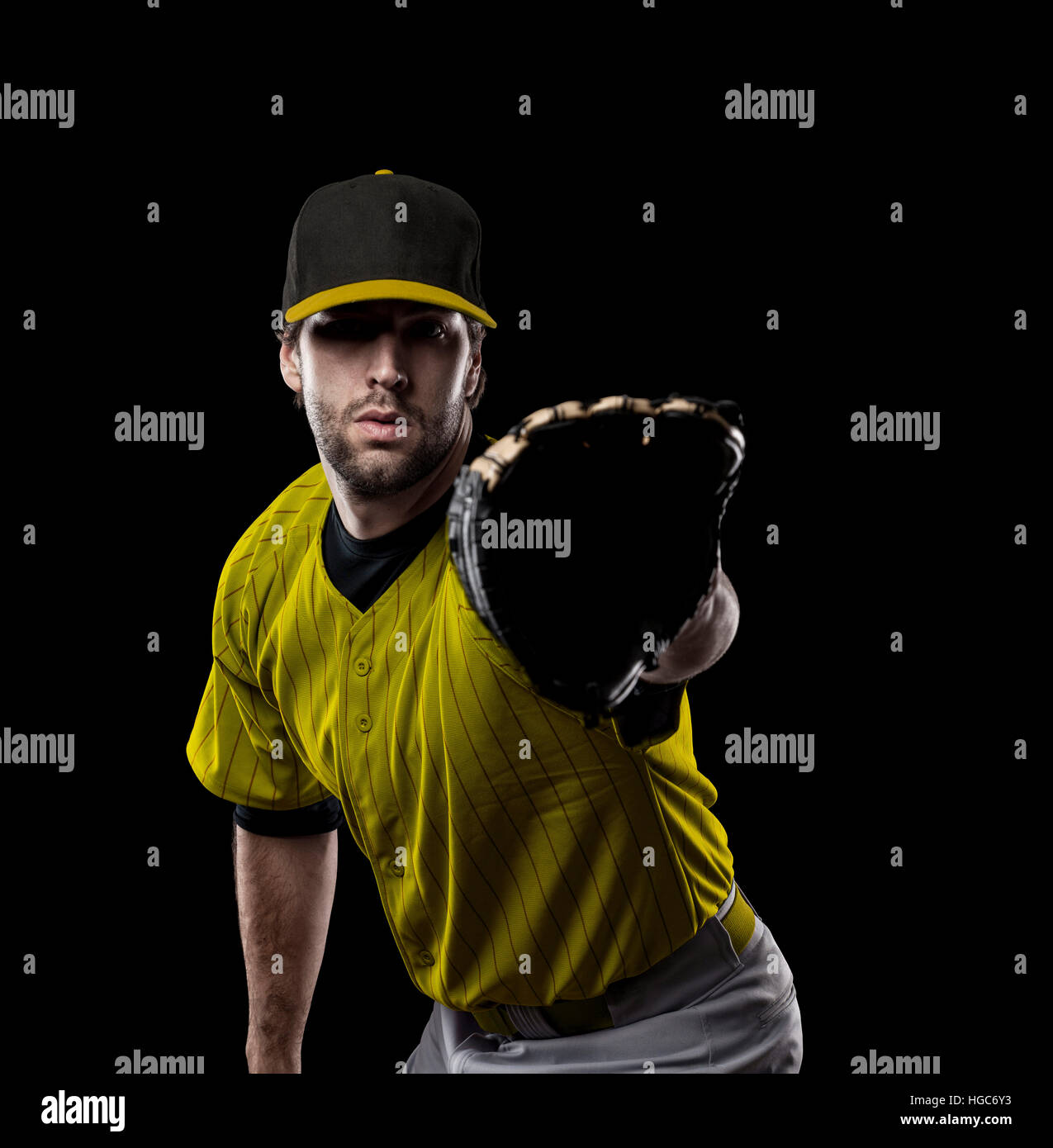 Baseball Player with a yellow uniform on a black background Stock Photo ...