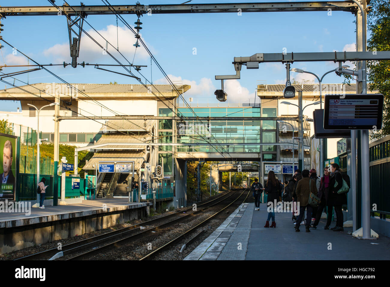 A Train station with some people waiting for commute Stock Photo - Alamy