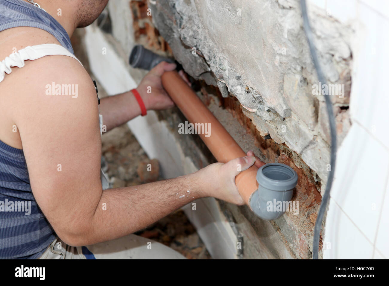 Plumber working on pipes Stock Photo - Alamy