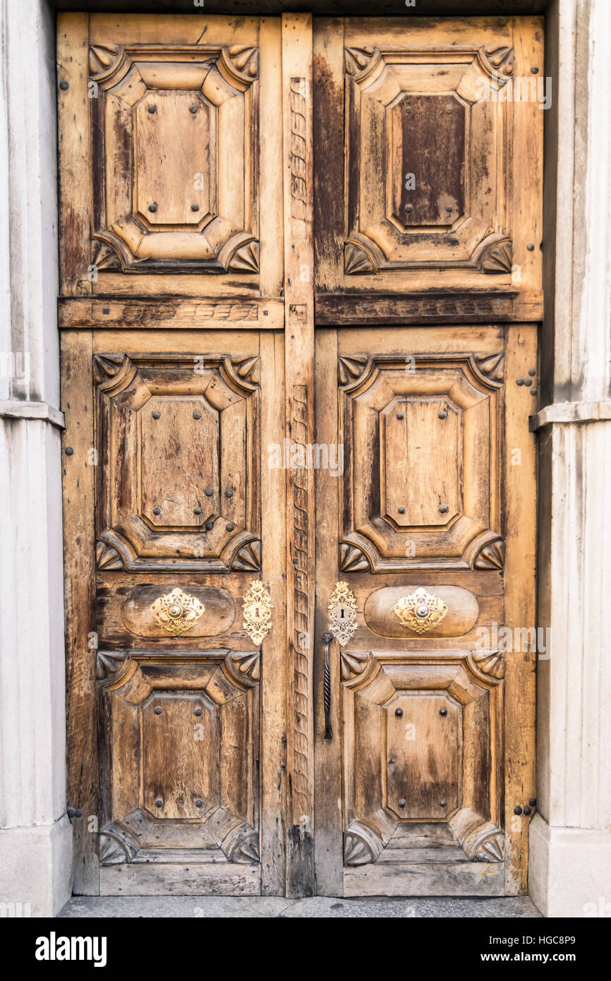 Entrance of a medieval cathedral with carved wooden door Stock Photo ...
