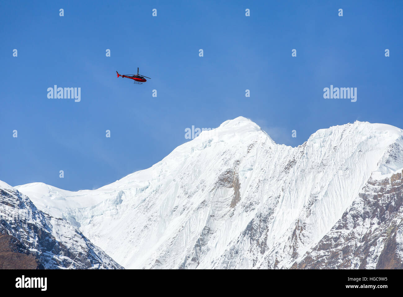 Rescue helicopter in high Himalayan mountains. Annapurna Range in Nepal ...