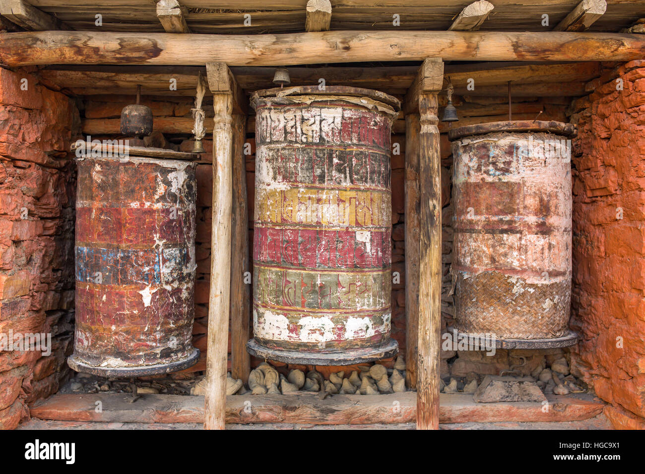 Buddhist prayer mani wall with prayer wheels in nepalese village on the ...