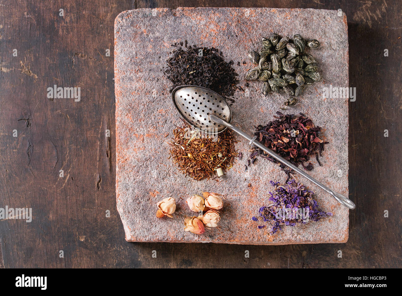 Variety of dry tea with teapot Stock Photo - Alamy