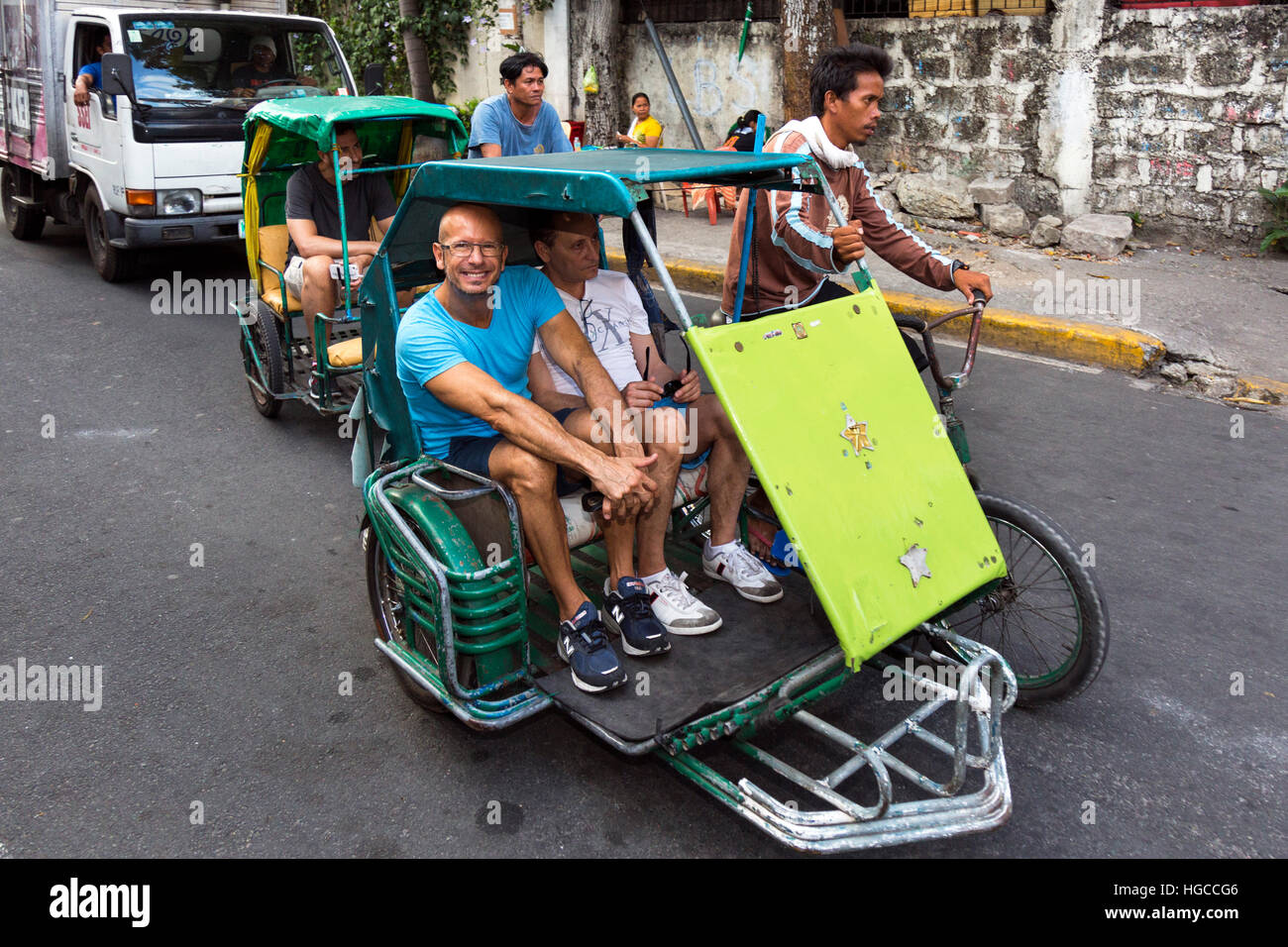 Filipino locals on tricycle taxi in Intramuros, Manila, Philippines ...