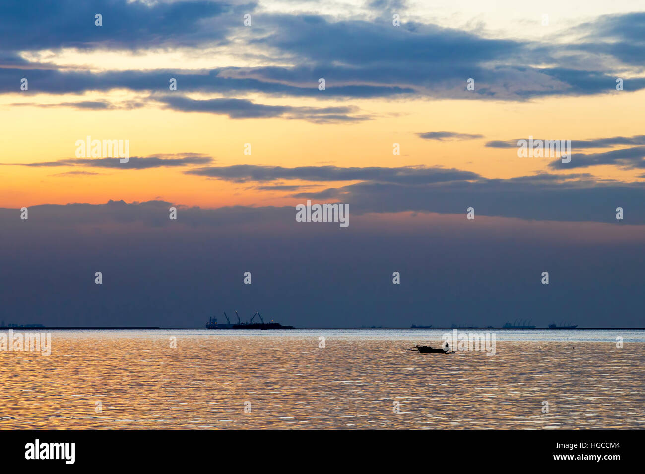 Rowing boat at sunset on Manila Bay, Philippines Stock Photo - Alamy