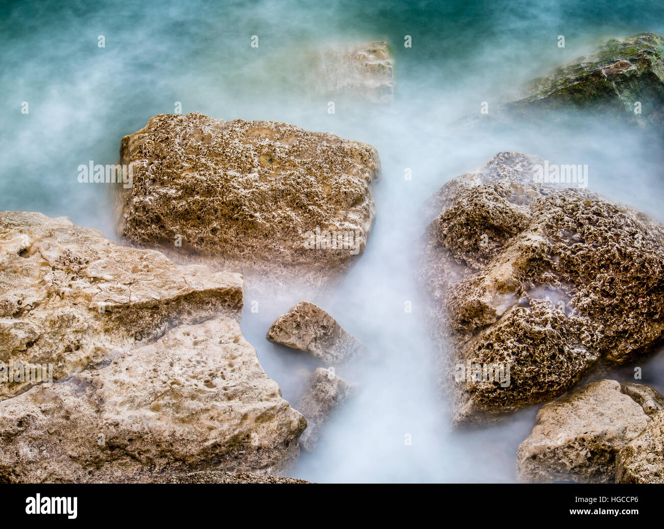 Fine Art Long exposure photograph of water lapping over rocks in the ...