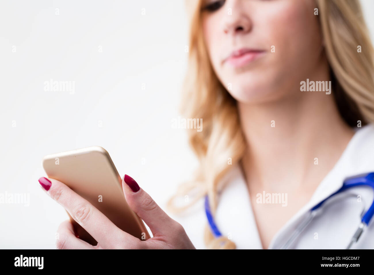 medical doctor using a mobile phone to check some app or patients e ...