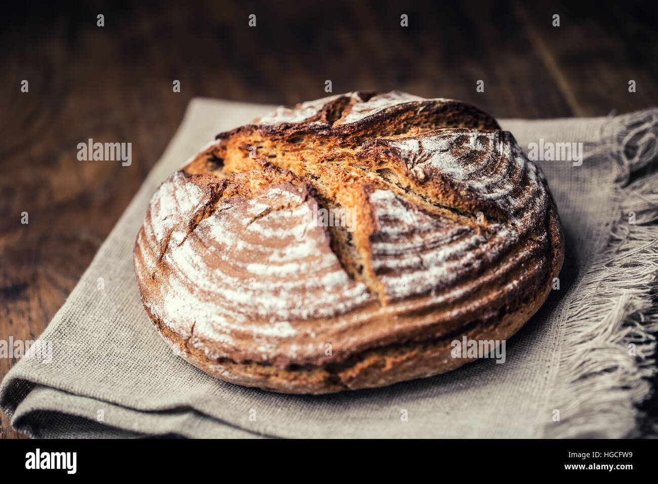 Bread.Fresh round crisp bread with caraway on wooden table Stock Photo ...