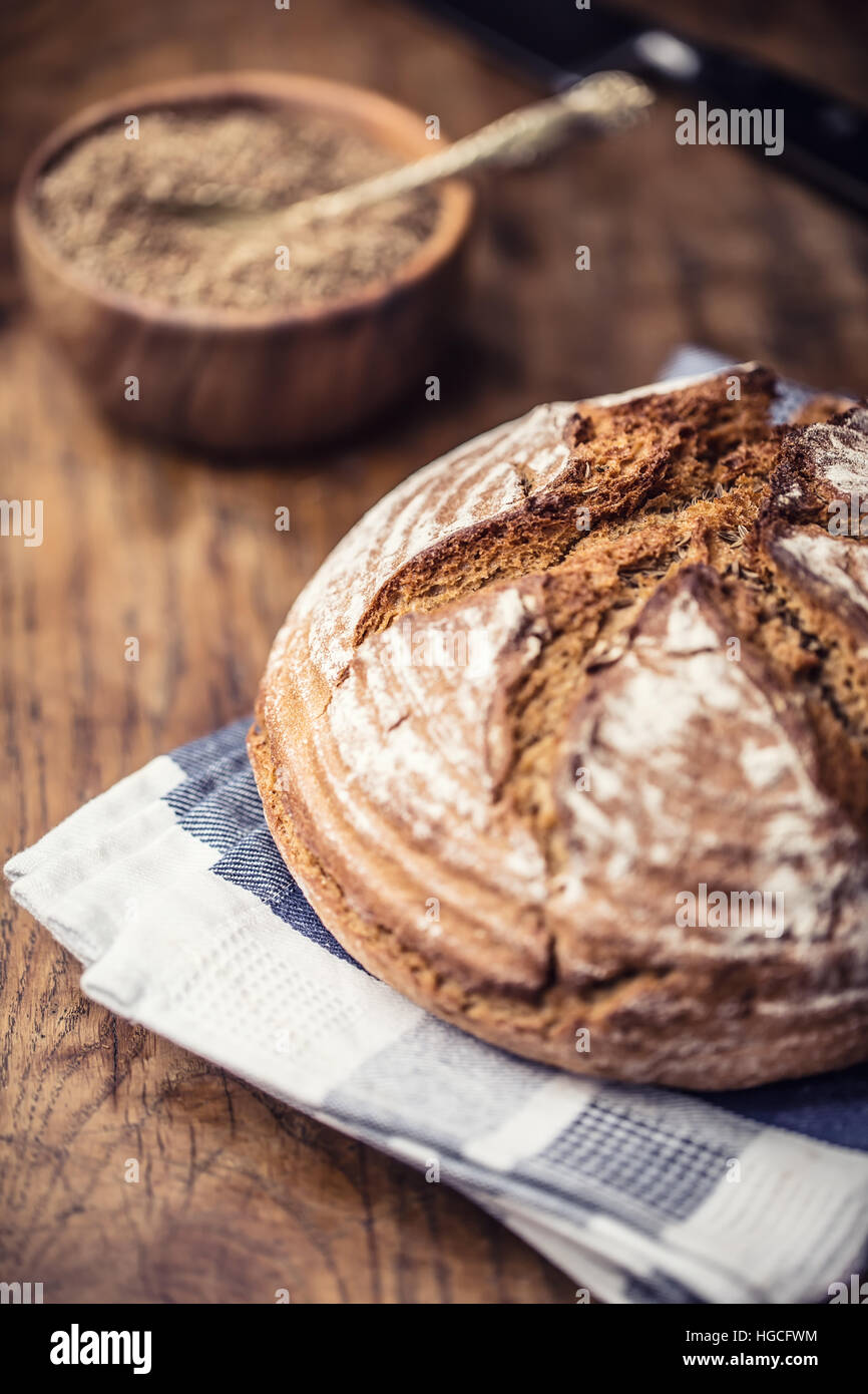 Bread.Fresh round crisp bread with caraway on wooden table Stock Photo ...