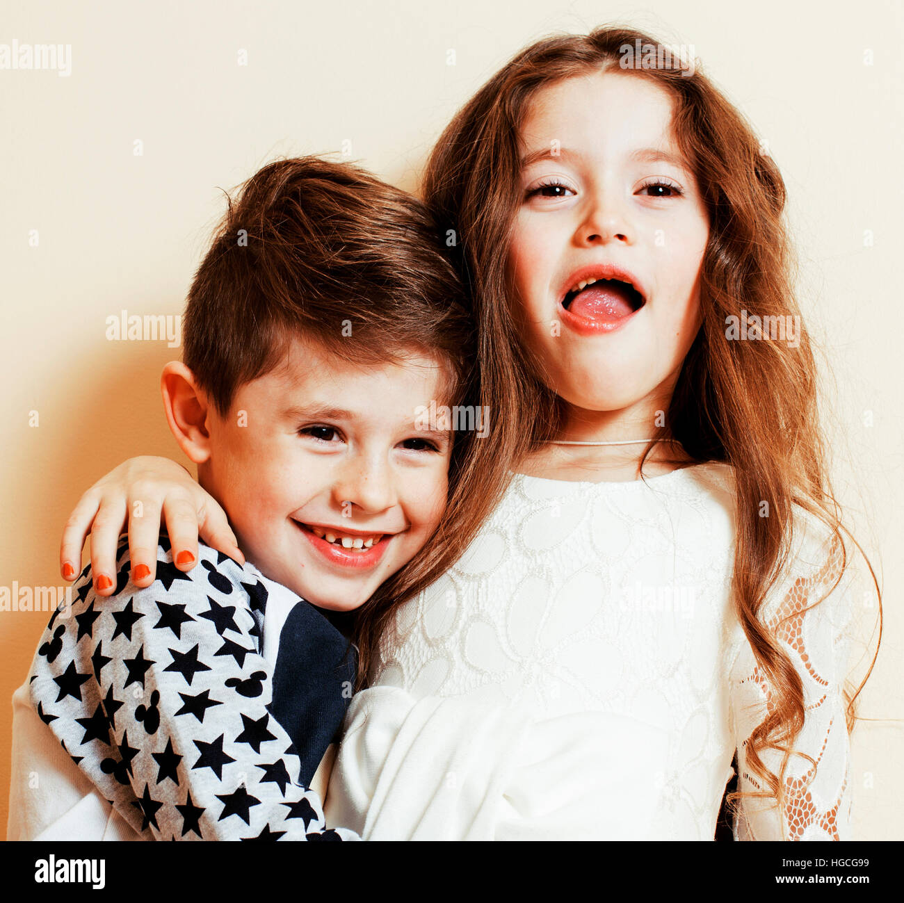 little cute boy and girl hugging playing on white background, ha Stock Photo - Alamy
