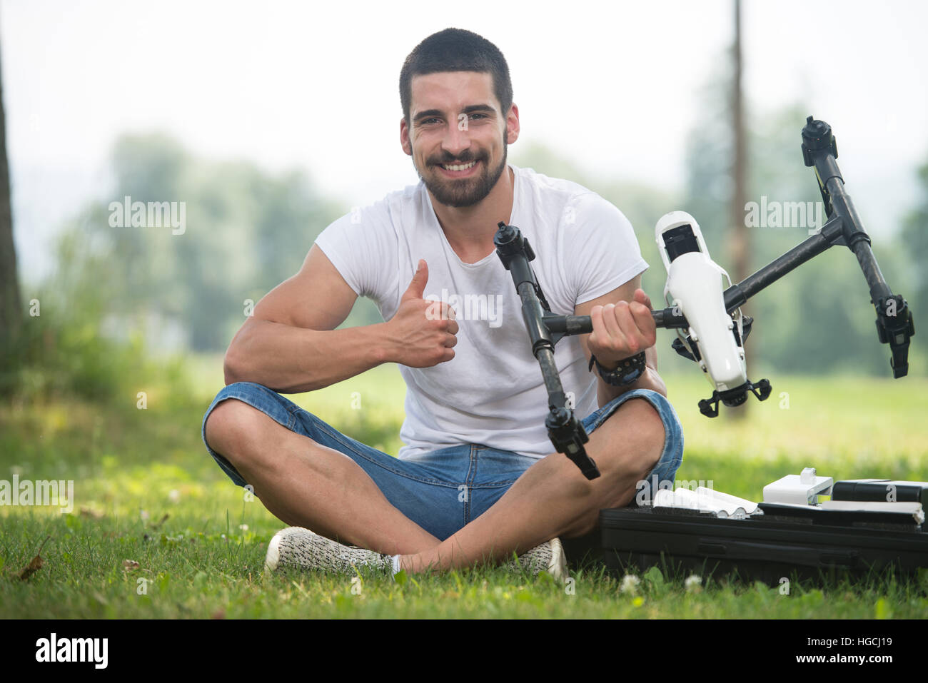 Portrait of Confident Young Engineer With Remote Control and Drone ...