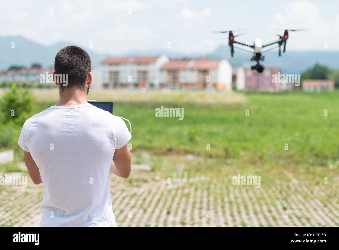 Man Operating Drone Flying or Hovering by Remote Control in Nature ...
