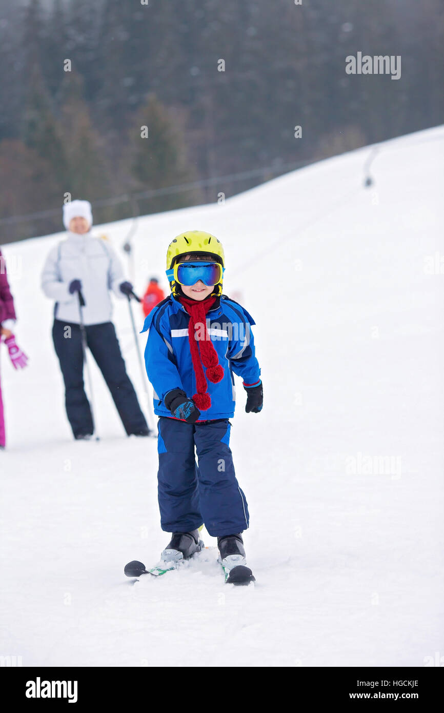 Young preschool child, skiing on snow slope in ski resort in Austria ...
