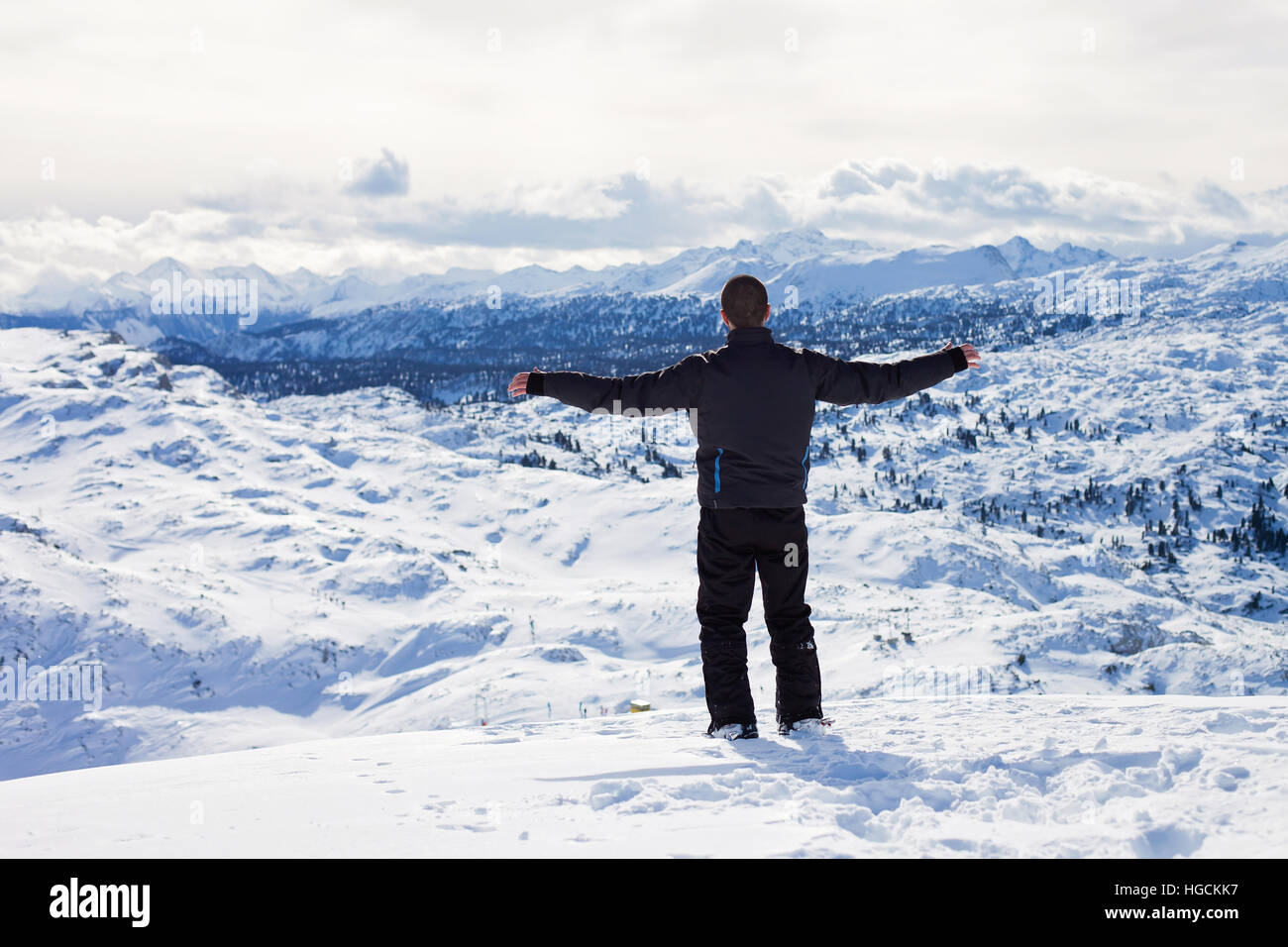 Young skier, enjoying the view from top of mountains in Austrian ski ...