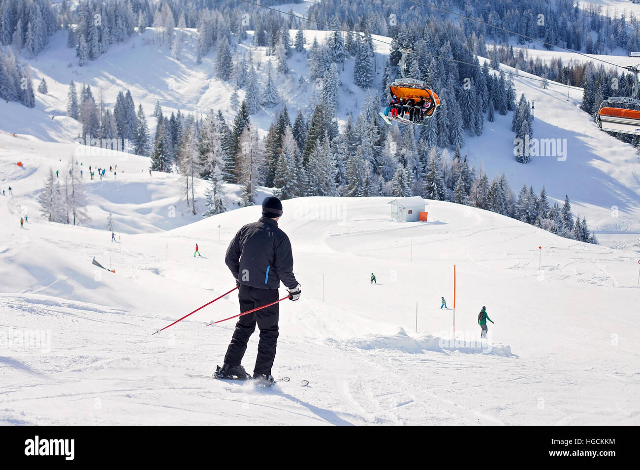 Young skier, enjoying the view from top of mountains in Austrian ski ...