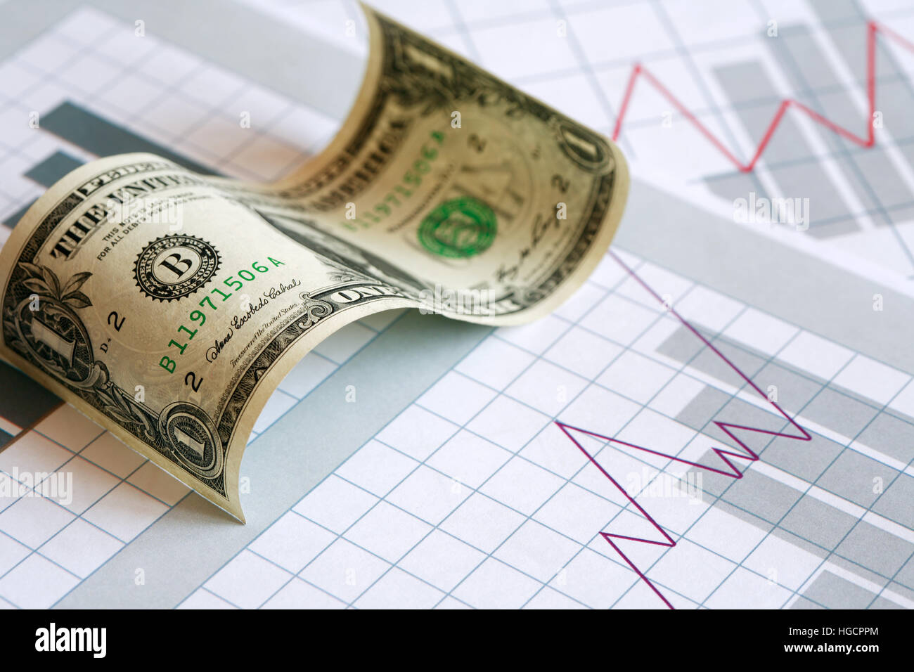 Business concept. Curved one dollar bill on paper background with ...