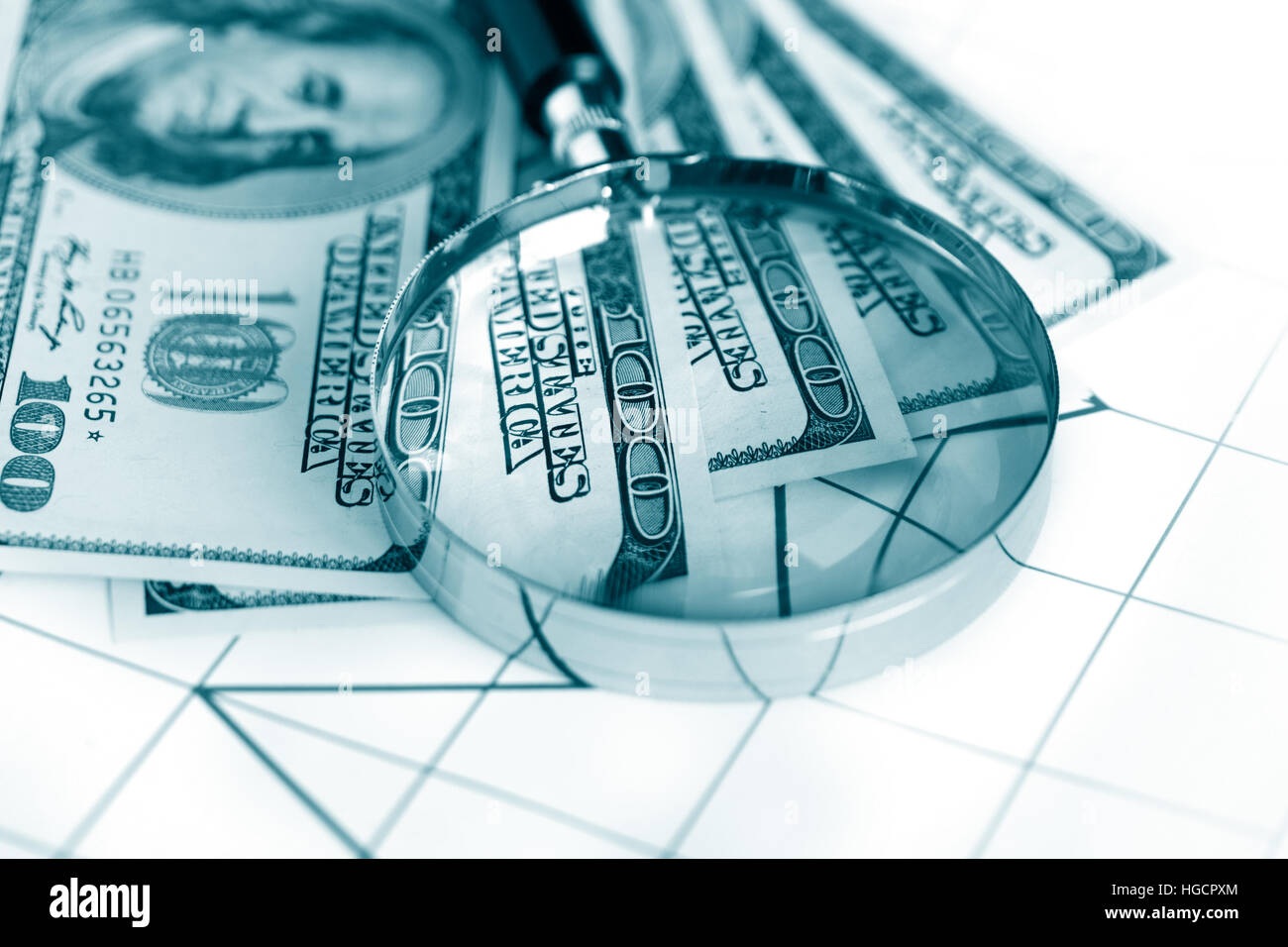 Business concept. Magnifying glass and money on paper background with ...
