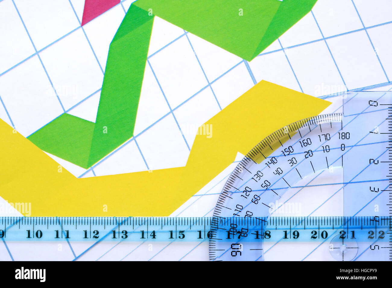 Two blue rulers on paper background with business chart Stock Photo - Alamy