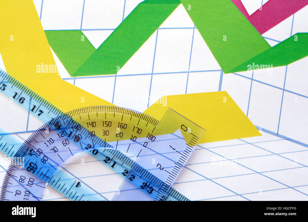 Two blue rulers on paper background with business chart Stock Photo - Alamy