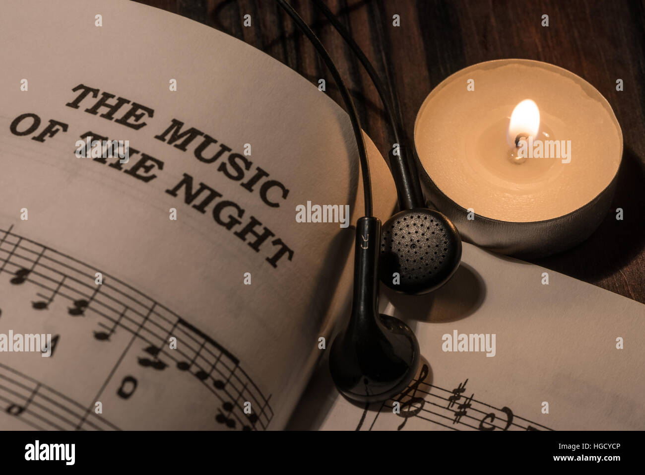 headphones, notes and candle - romantic music of the night Stock Photo ...
