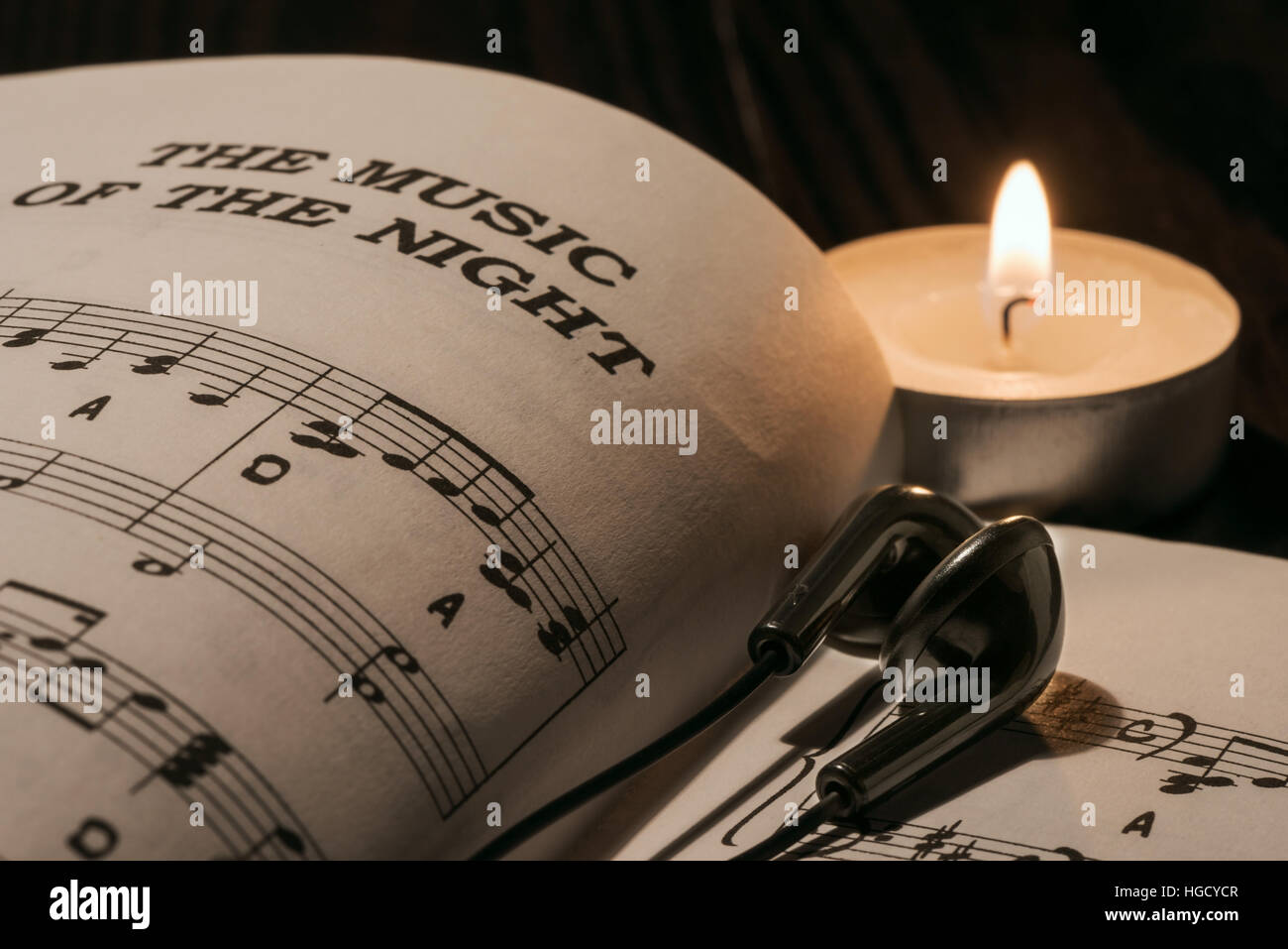 headphones, notes and candle - romantic music of the night Stock Photo ...
