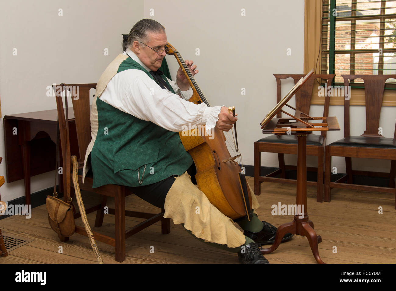 Colonial Williamsburg interpreter string instrument Stock Photo - Alamy