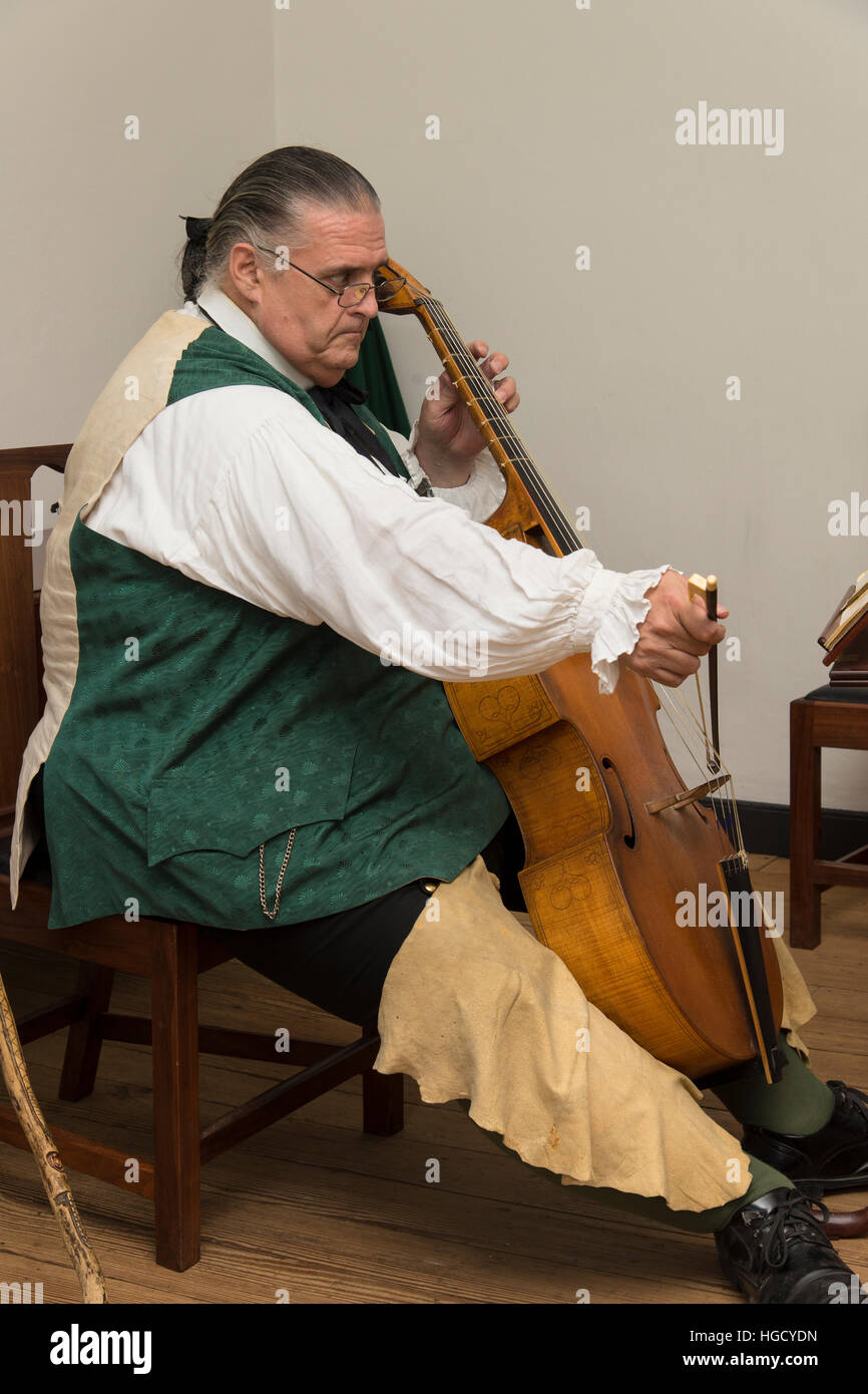 Colonial Williamsburg interpreter string instrument Stock Photo - Alamy