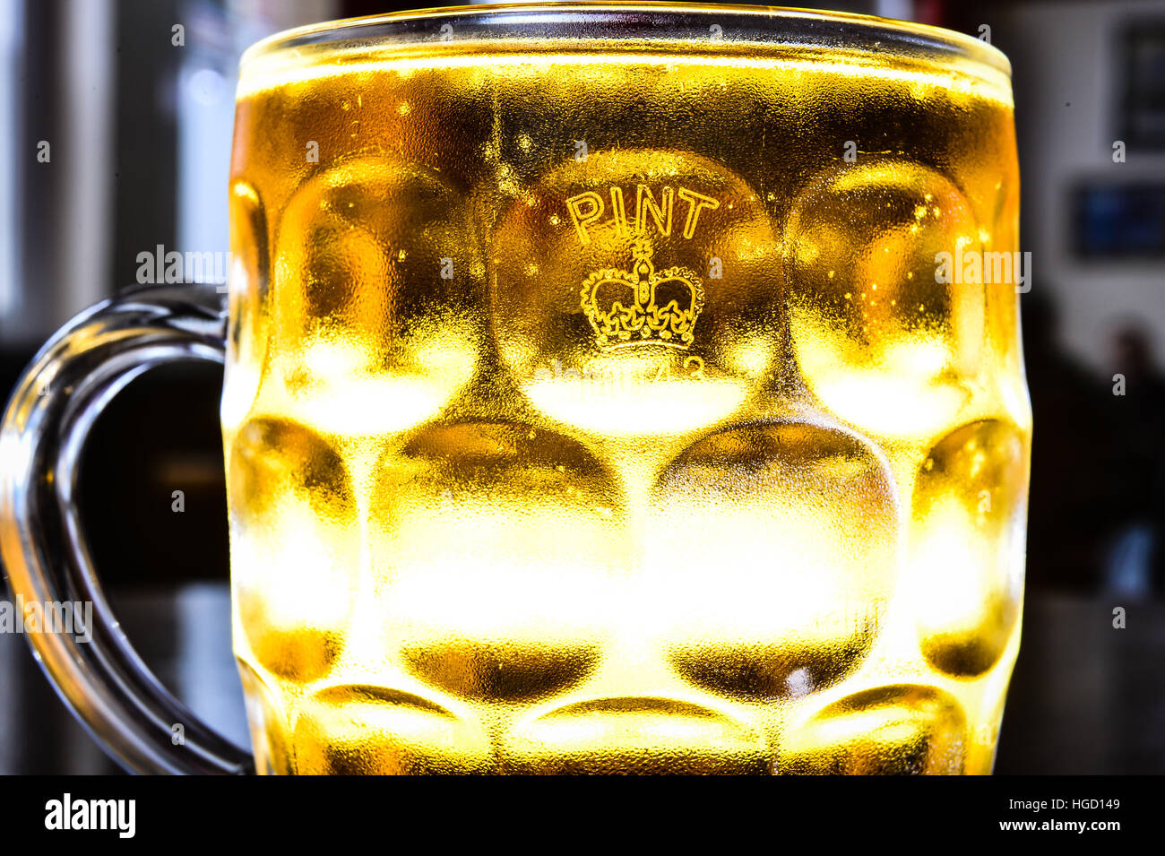 A dimpled pint glass etched with the Crown stamp rather than the ...