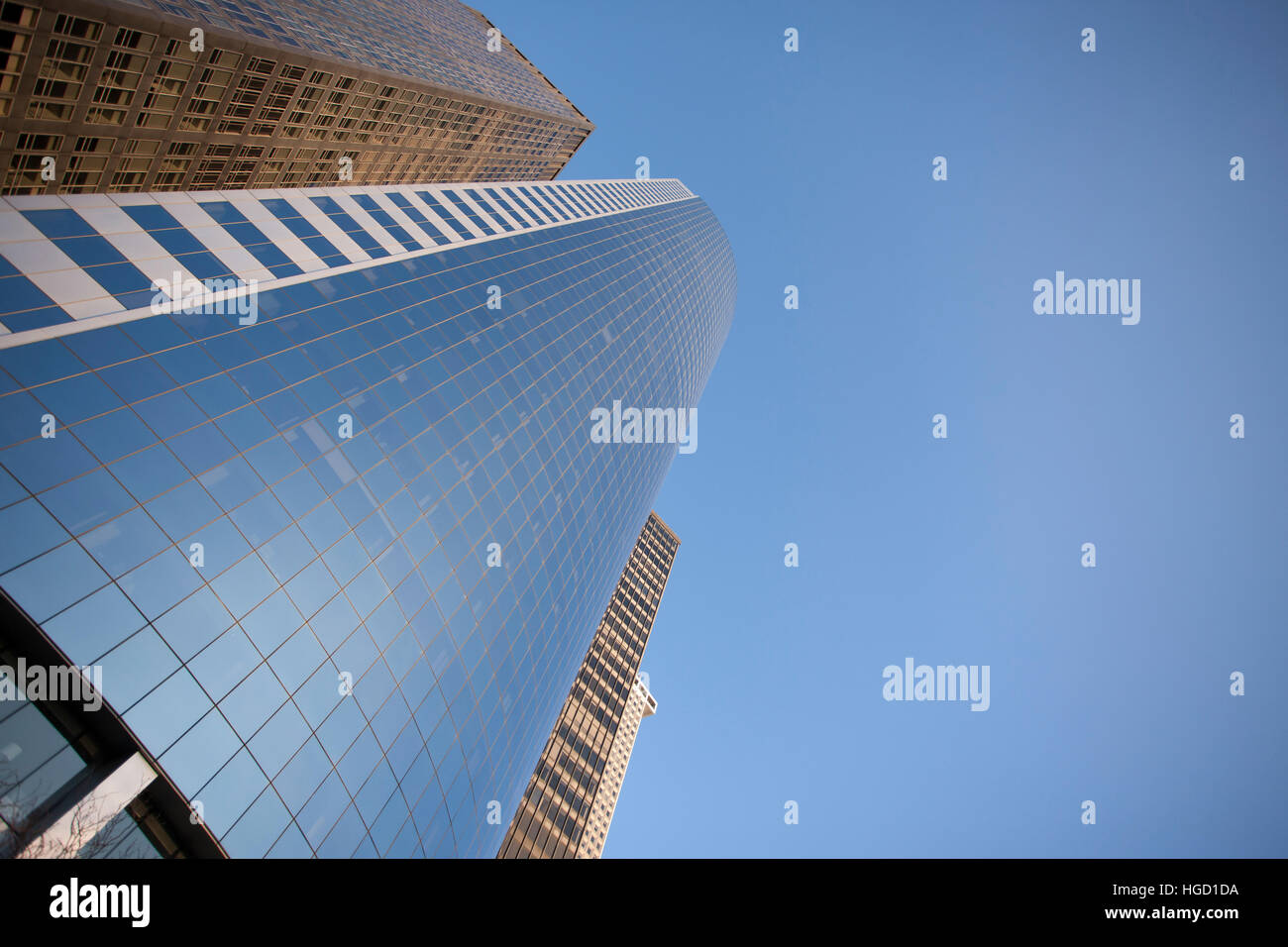 New York city, looking skyward at a Commercial building against a blue ...