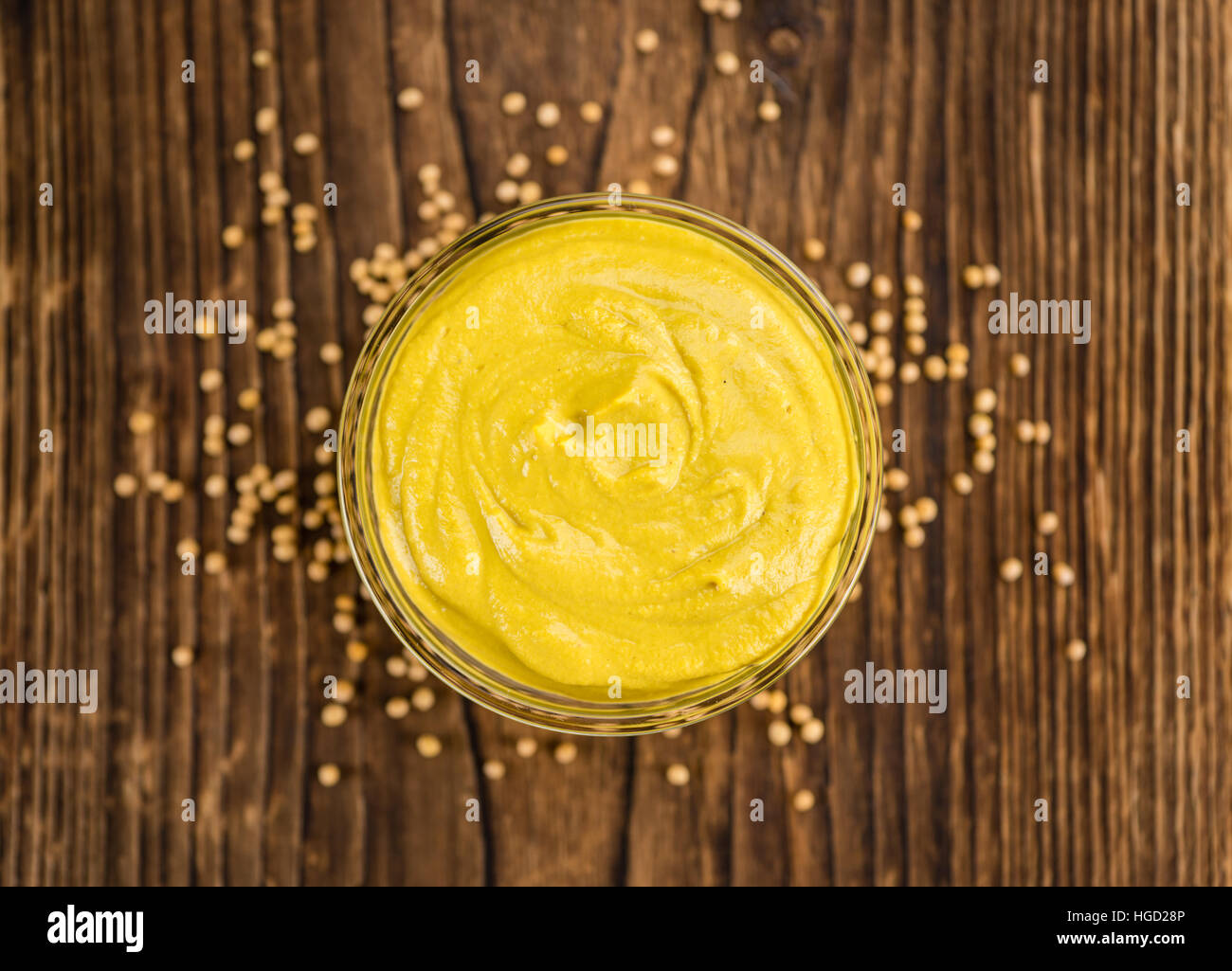 Mustard as high detailed close-up shot on a vintage wooden table ...