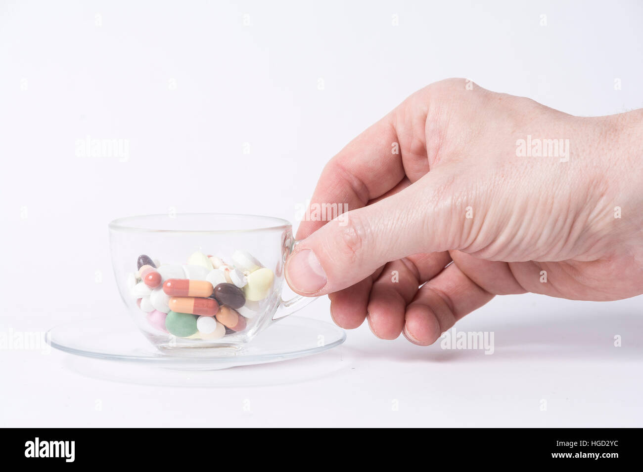 Human hand take a transparent coffee cup with pills and medicine inside ...